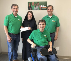 Stine donates $10,000 to Catholic Charities